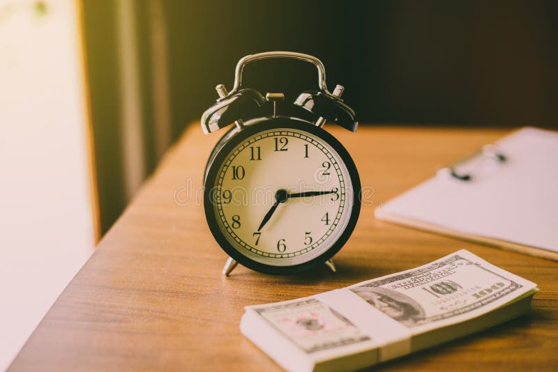 Clock and Money US Dollar Banknote or Bill on a Working Table,Saving ...