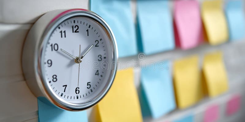 A Clock Mounted on a Wall with Sticky Notes Attached To it Stock Image ...