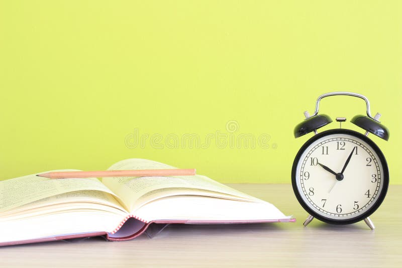 Clock Near Open Book on Green Background Stock Image - Image of hand ...