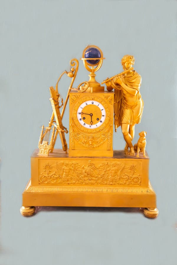 The Clock is an Old Rectangular Yellow Color with a Boy Playing a Flute ...