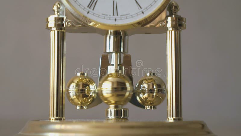 Clock with a Pendulum in a Form of Rotating Balls Stock Footage - Video ...