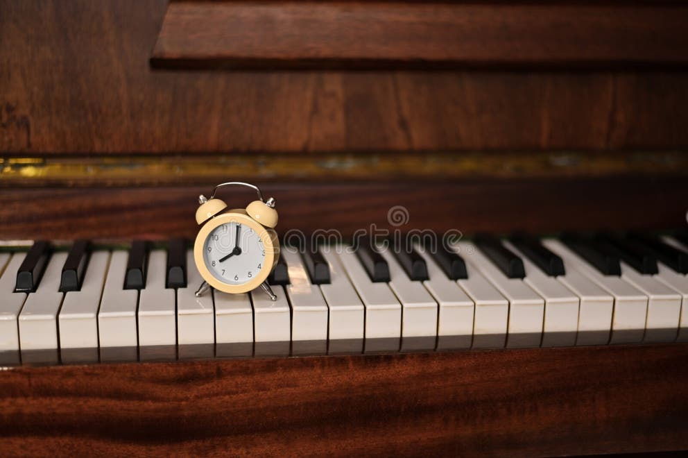 The Clock on the Keyboard of an Old Piano Stock Photo - Image of piano ...