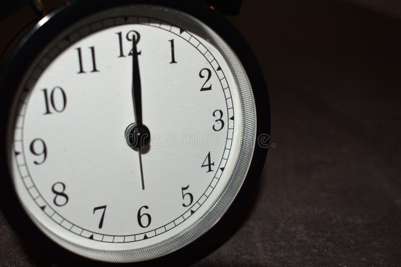 Clock Pointing To Different Times Stock Photo - Image of table, black ...