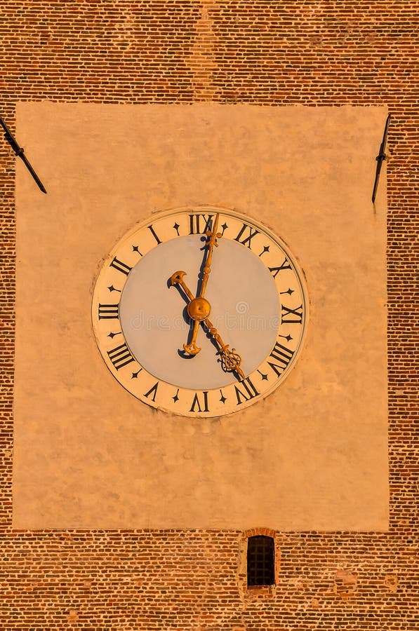 A Clock with Roman Numerals on a Brick Wall Stock Photo - Image of hour ...