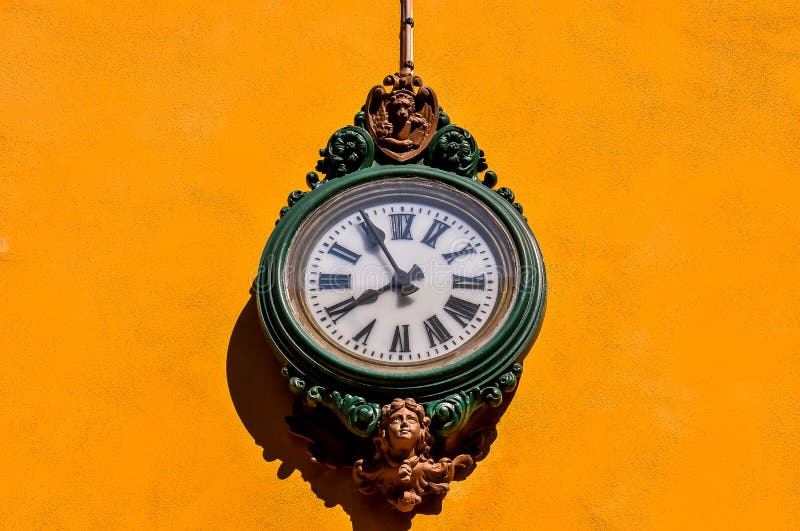 A Clock with Roman Numerals on a Green Frame Stock Photo - Image of ...