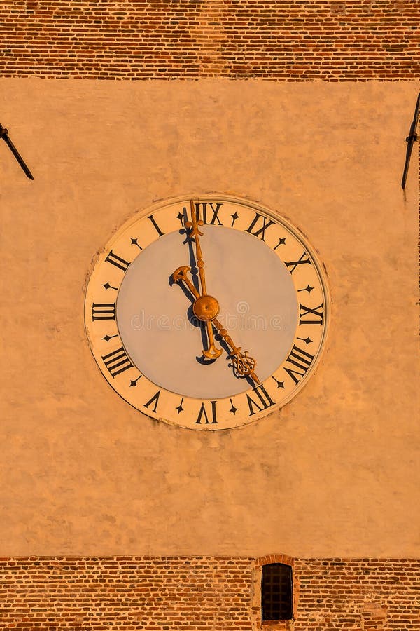A Clock with Roman Numerals on a Wall Stock Image - Image of hour ...