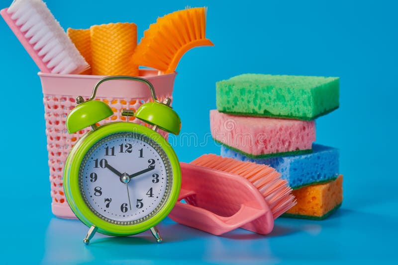 Clock and a Set of Cleaning Accessories on a Blue Backdrop. Studio Shot ...