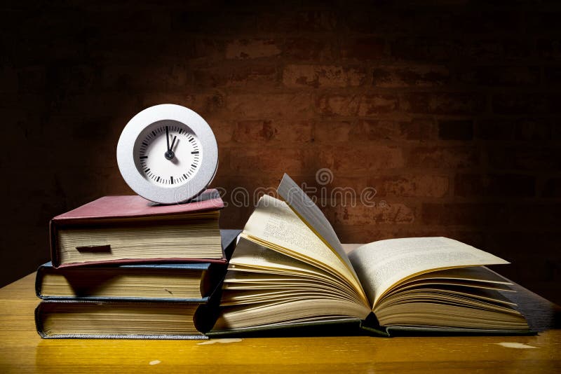 Clock Showing Hours are on the Stack of Books Stock Image - Image of ...