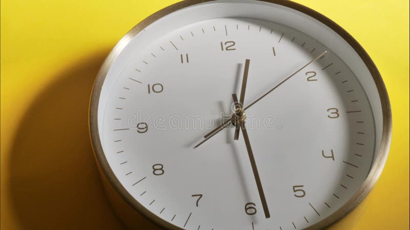 The Clock is Ticking Very Fast. a Wall Clock on a Yellow Background ...