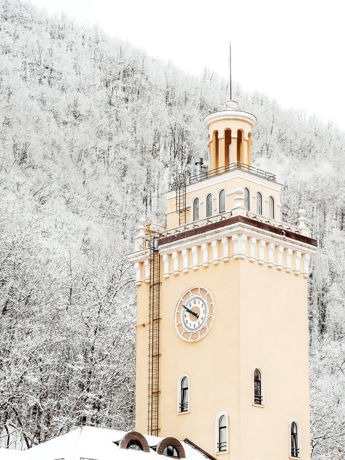 The Clock Tower on the Background of the Mountain with Snow-covered ...