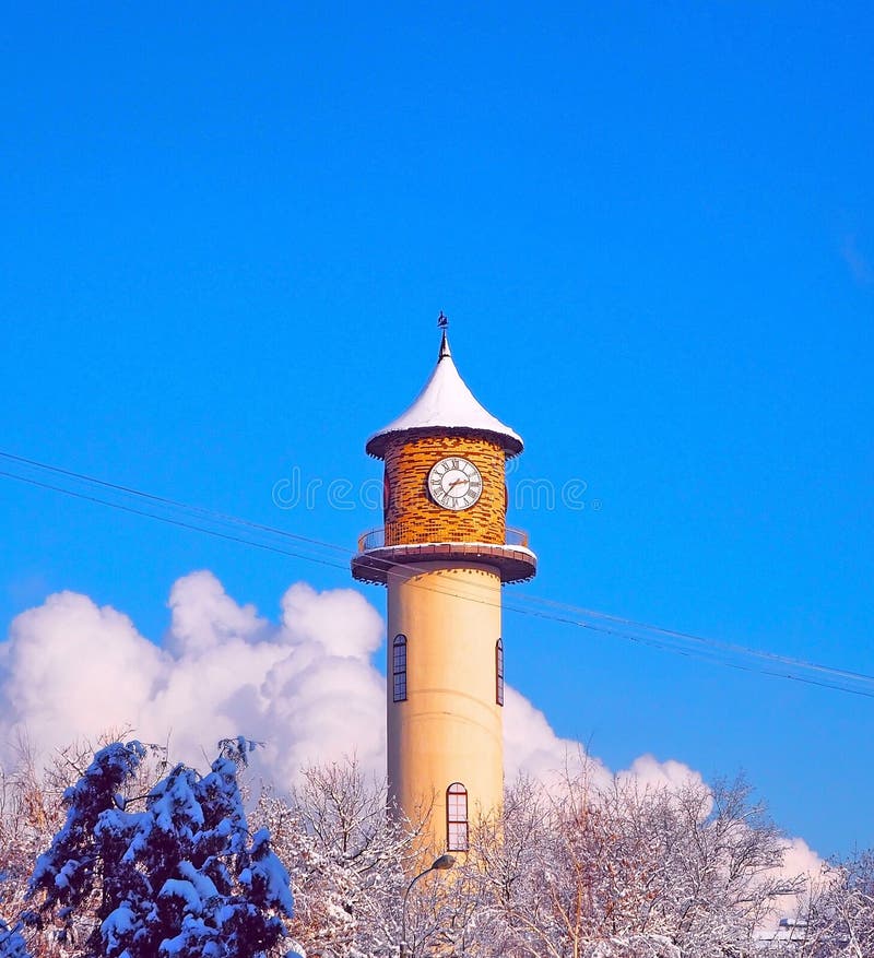 A Clock Tower on a Background of Trees in the Snow. a Sunny Frosty Day ...