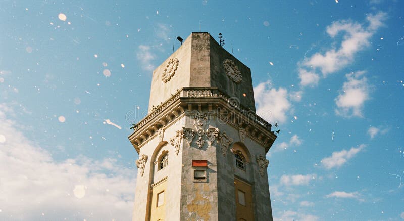 Clock Tower with Ornate Architectural Features Under a Blue Sky with ...