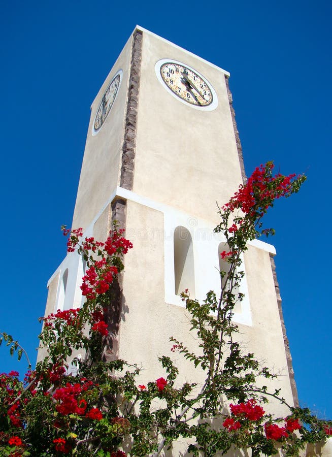 Clock Tower Surrounded by Flowers and Blue Sky Stock Photo - Image of ...