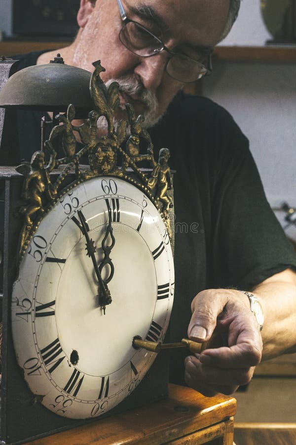 Clockmaker Winding Up a Clockwork Machine Stock Image - Image of minute ...