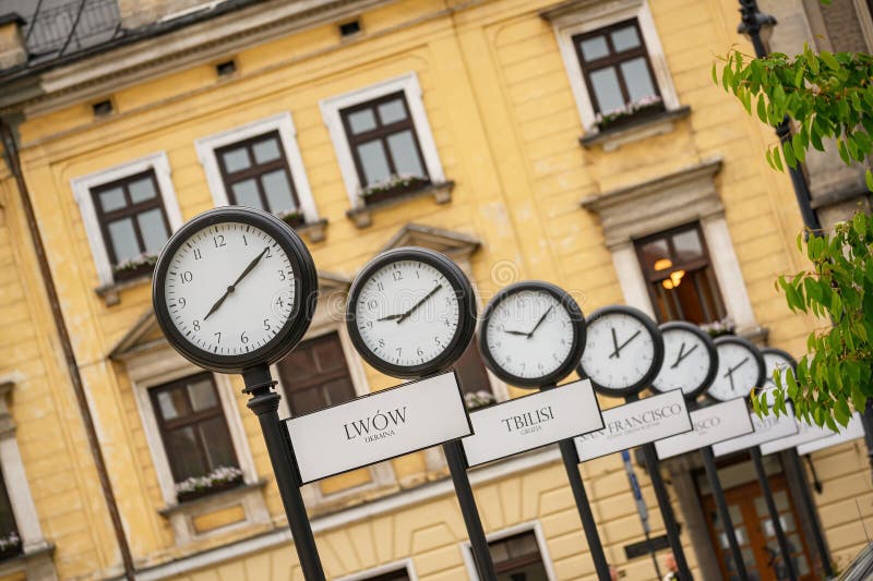 Clocks Showing the Current Time in Cities Around the World. Krakow ...