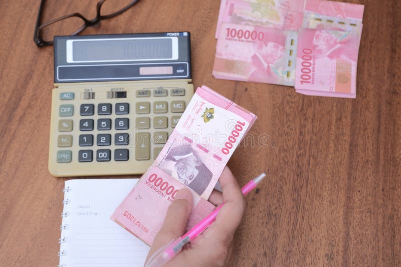 Cloe Up Shot of a Desk with Hand Counting Money Using Calculator Stock ...