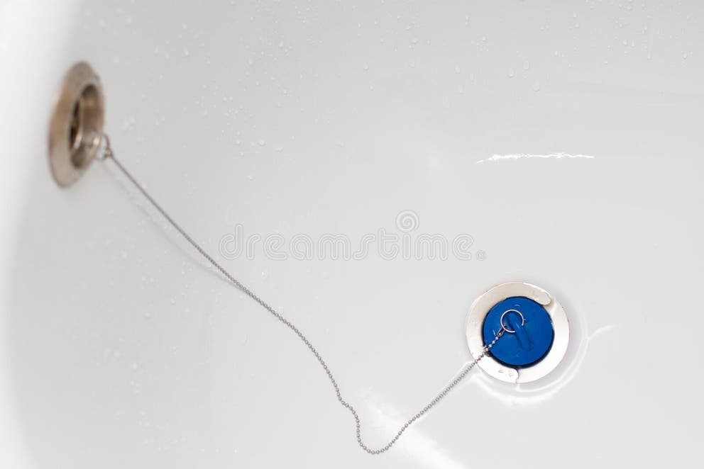 Drain plug on white bathe stock photo. Image of bathroom - 137272852