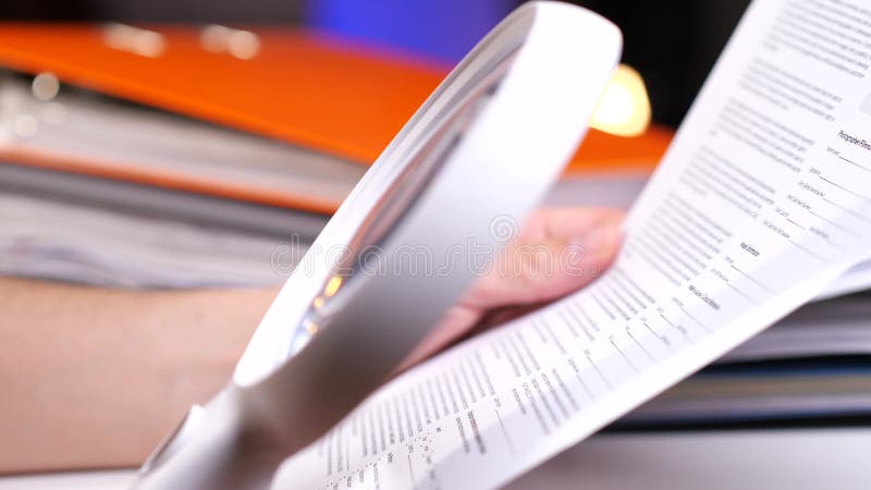 Close Examination of Document Text Using a Magnifying Glass Stock Video ...