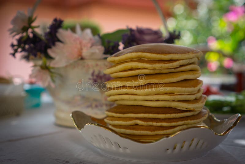 Pancakes on the Table with Flowers in the Background. Stock Image ...