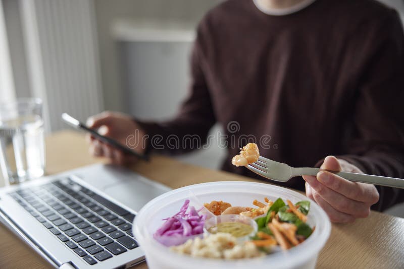 Close of Man Eating Healthy Lunch at Office Deak Whilst Using Laptop ...