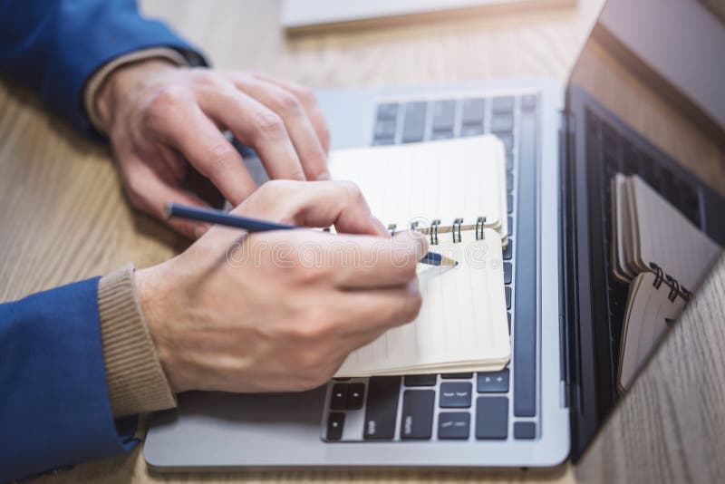Close Perspective of a Man S Hand Making Entries in a Notepad on a ...