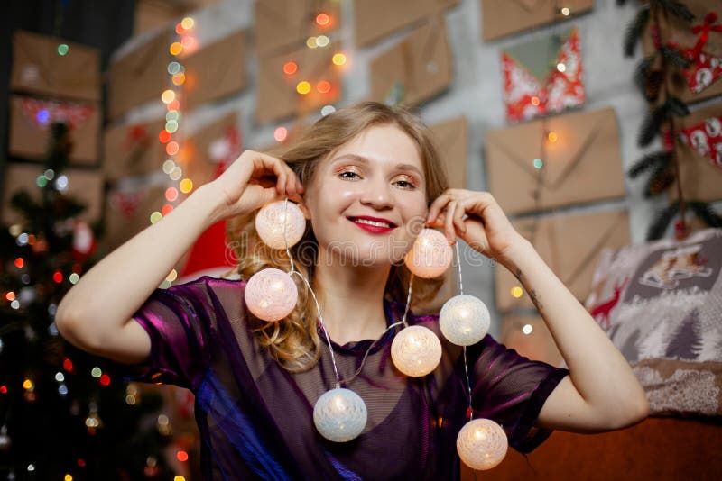 Close Portrait of a Cute Lady with Christmas Lights, Looking at the ...