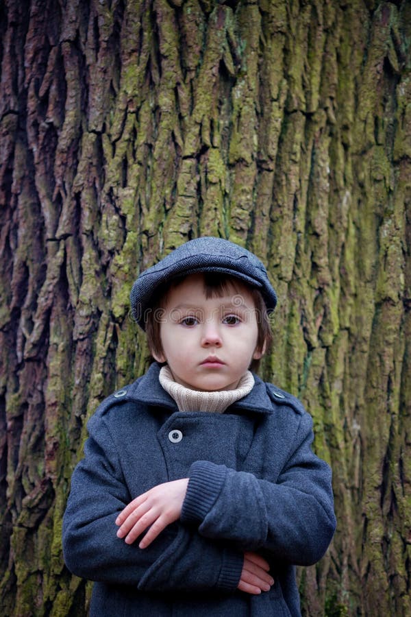 Close Portrait of a Little Boy in the Forest, Standing Next To a Stock ...
