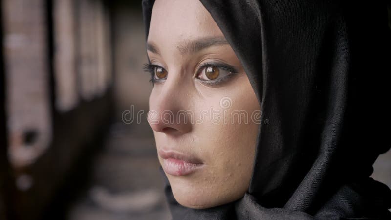 Close Portrait Of Young Serious Beautiful Woman Looking At Camera