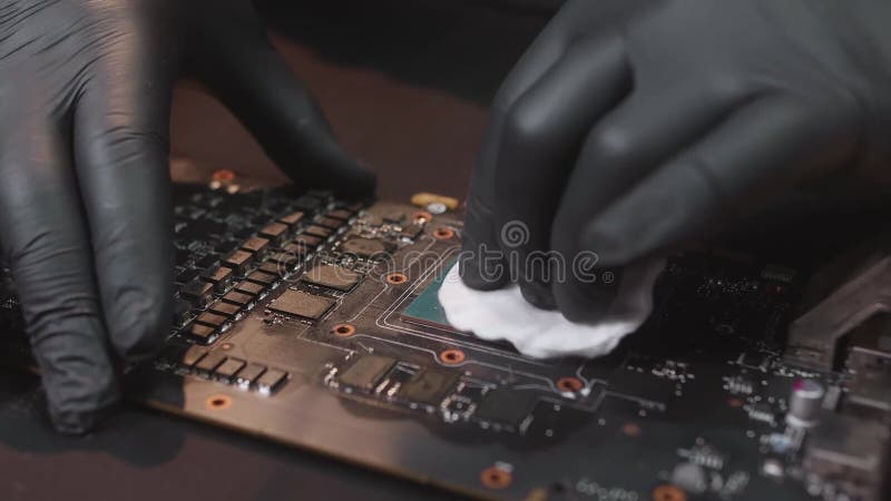 Repairer of Electronics Uses a Napkin To Remove a Thermal Grease from a ...