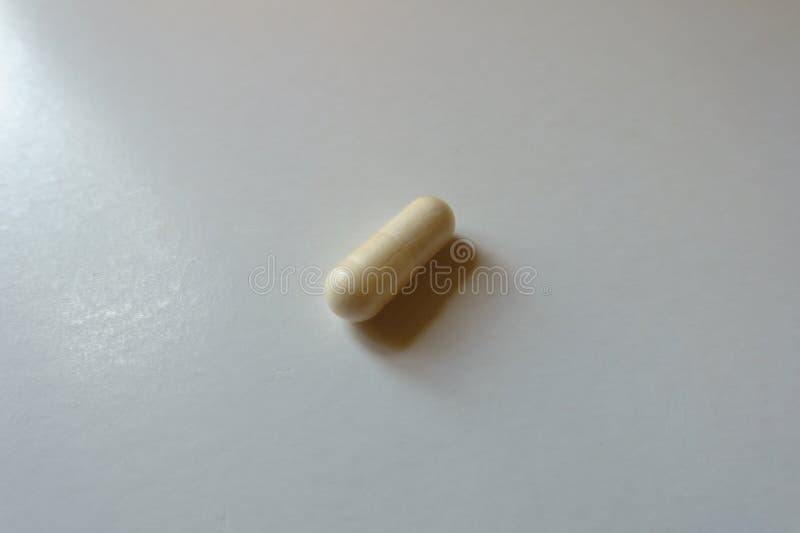 Close Shot of One Beige Capsule of Probiotic Dietary Supplement Stock ...
