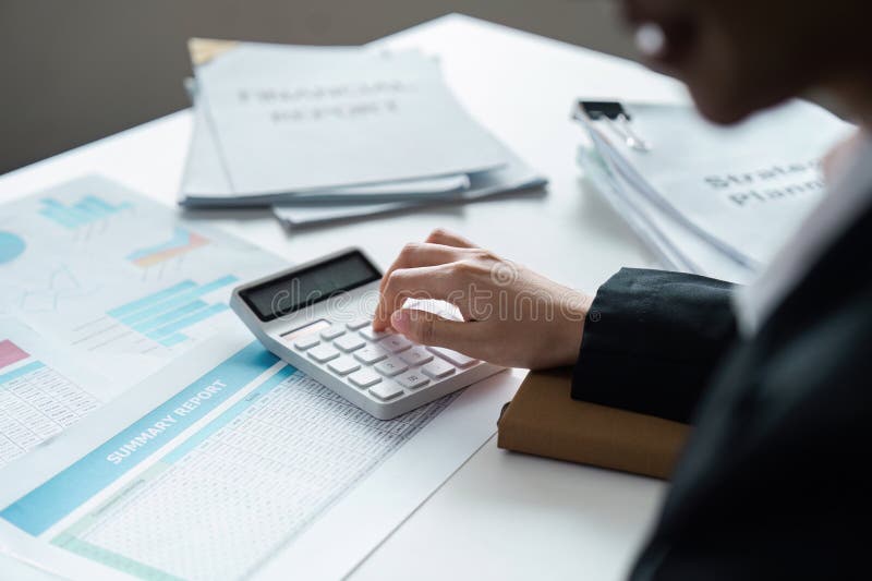 Business Accountant Working on Financial Reports with Calculator and ...