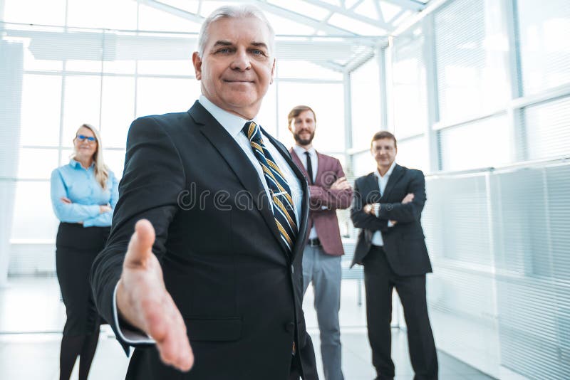 Adult Confident Businessman Holding Out His Hand For A Handshake Stock