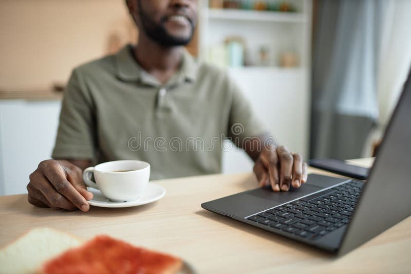 Close Up of Black Man Using Laptop at Kitchen Table Stock Photo - Image ...