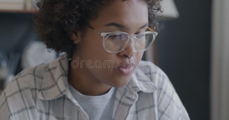 Close-up of African American Woman Developer Using Laptop Looking at ...