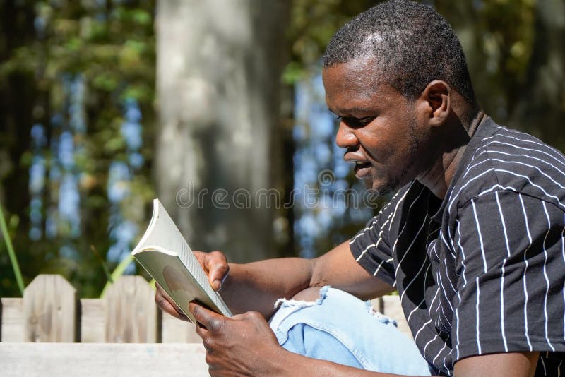 Close Up of African Man Reading a Book. Education in a Park Stock Image ...