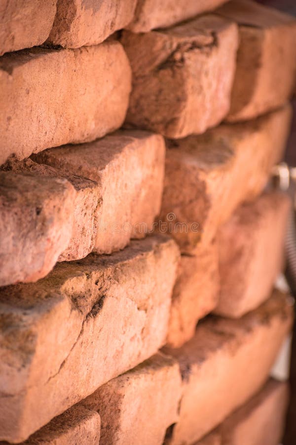 Wall of bricks piled up stock photo. Image of abstract - 217469168