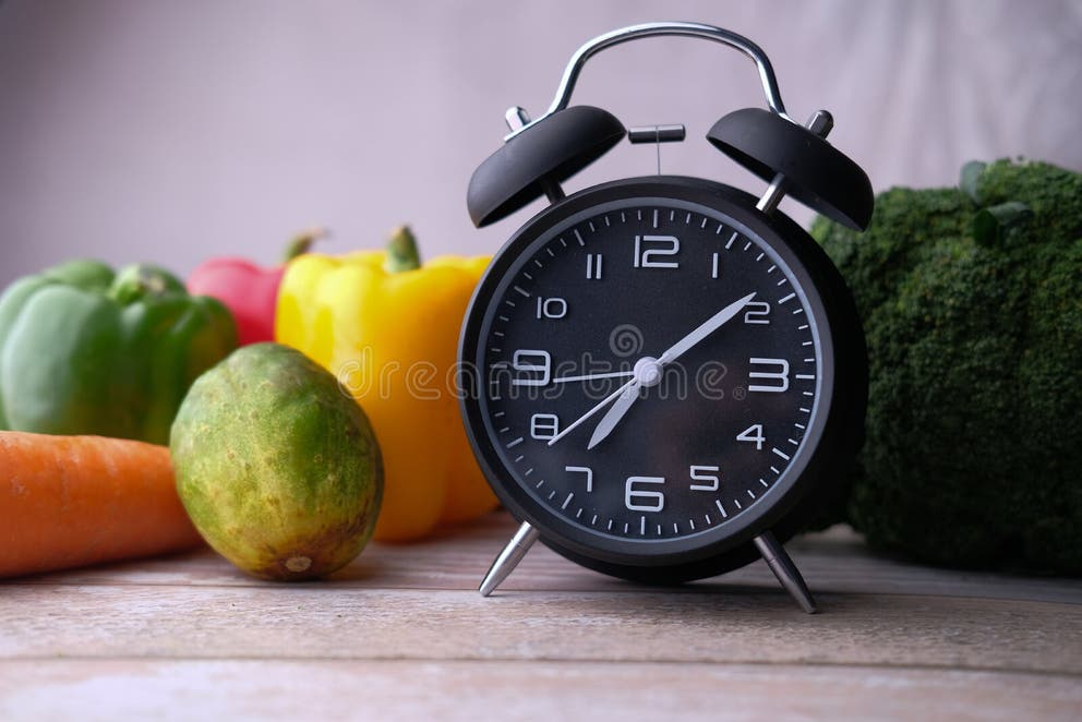 Close Up of Alarm Clock and Vegetable on Table Stock Photo - Image of ...