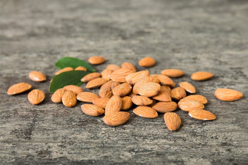 Close-up of Almonds Nuts with Leaves on Table Background. Top View ...