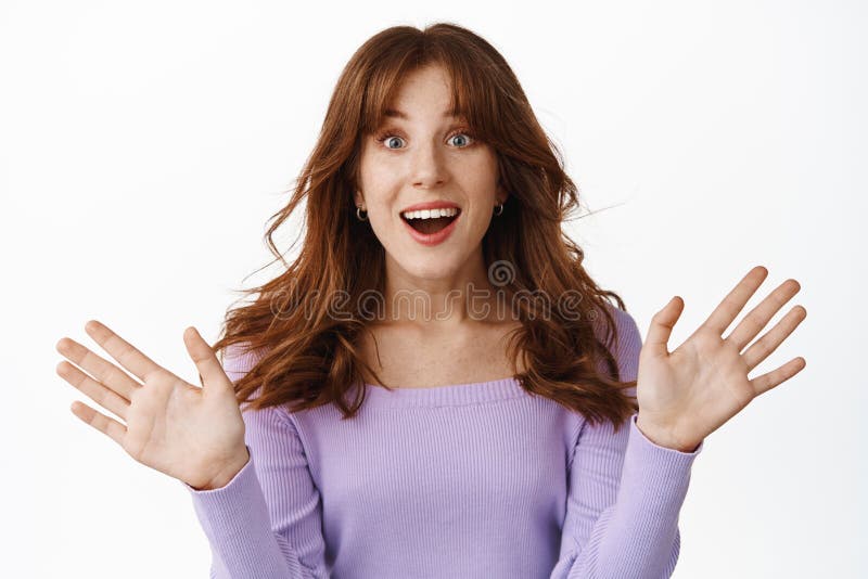 Close Up Of Amazed And Excited Redhead Woman Spread Hands Sideways And