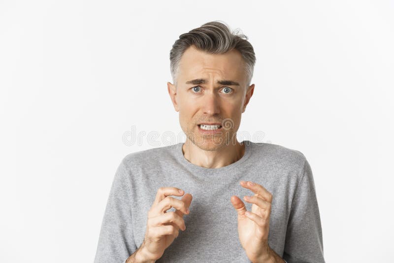 Close-up of Nervous Man Making Wish, Holding Fingers Crossed and Biting ...