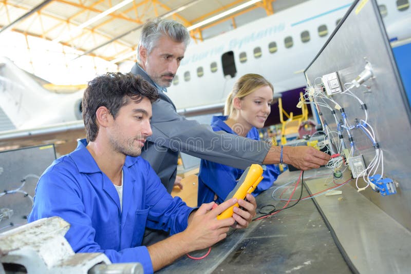 Close Up Apprentices and Aircraft Electrical Equipments Stock Image ...