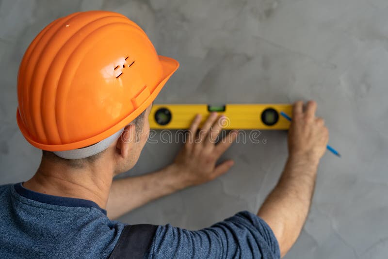 Close-up Architect or Construction Worker in Hardhat Checking Level of ...