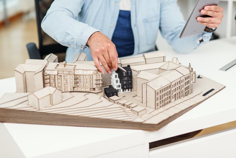 Close Up Architect`s Hands Constructing Model of Buildings and Examines ...