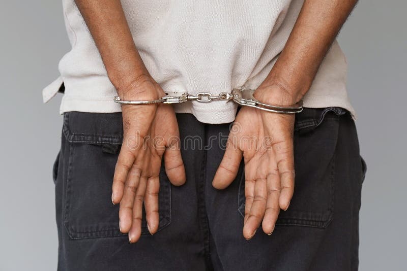 Criminal Hands Locked in Handcuffs. Close-up View Stock Image - Image ...