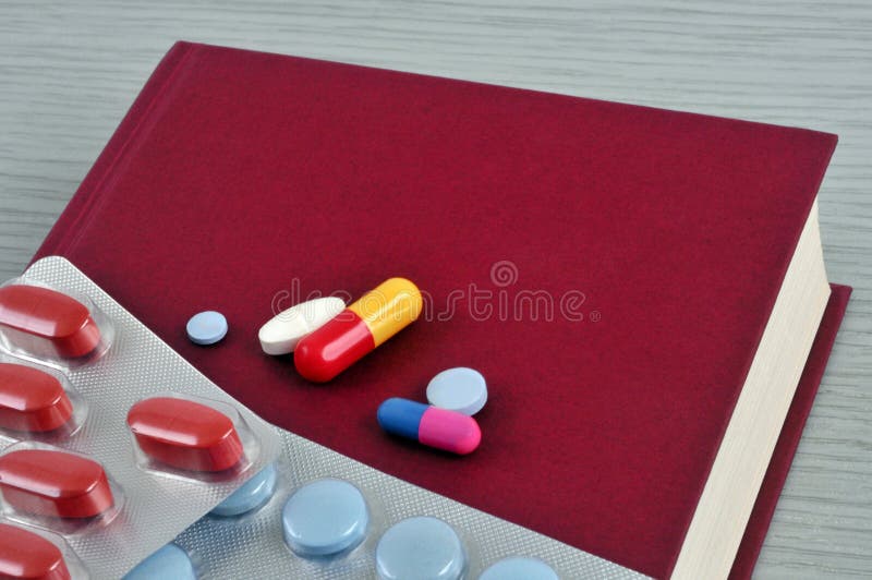 Various Medicines on a Red Book Close-up Stock Photo - Image of tablet ...