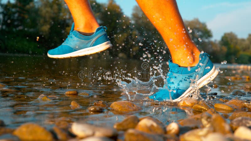 CLOSE UP: Athletic Young Man Running in Refreshing Glassy Stream on a ...