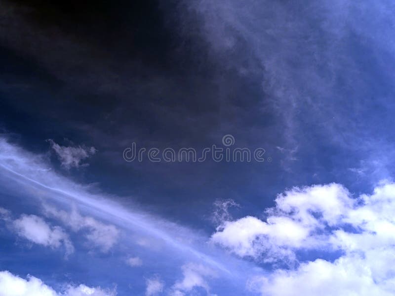 Close Up of Atmospheric Blue Black Sky with Whispy White Clouds Stock ...