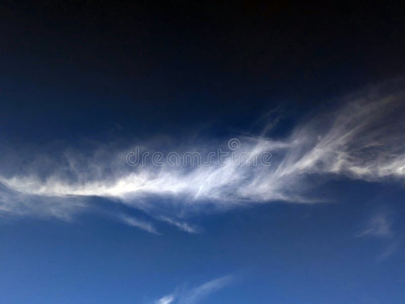 Close Up of Atmospheric Blue Black Sky with Whispy White Clouds Stock ...