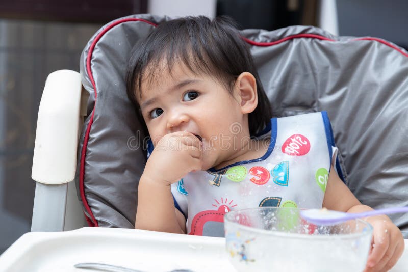 Close Up Baby Eating Meal by Herself Stock Image - Image of home, cute ...