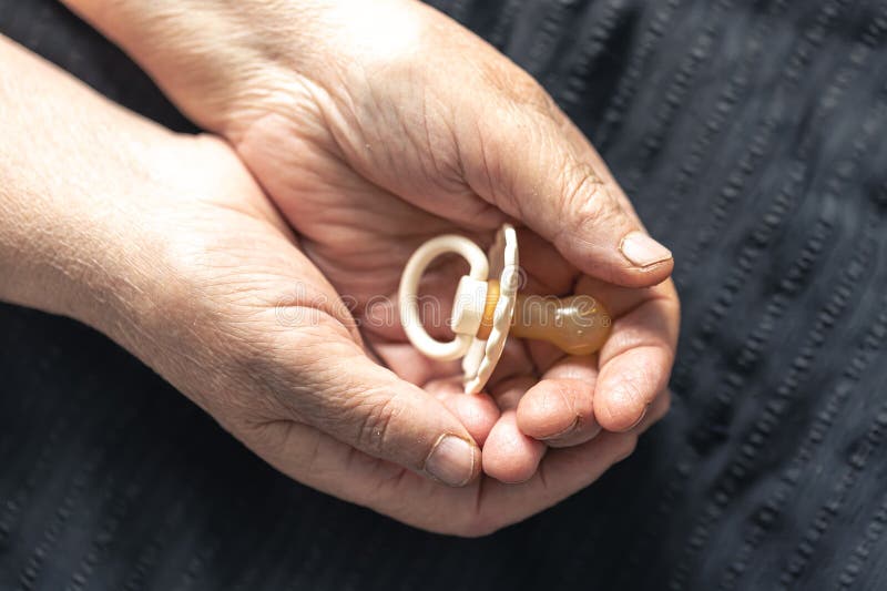 Close-up, a Baby Pacifier in the Hands of a Grandmother. Stock Photo ...